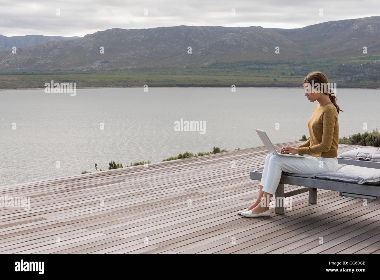 Side profile of a beautiful woman using a laptop Stock Photo - Alamy