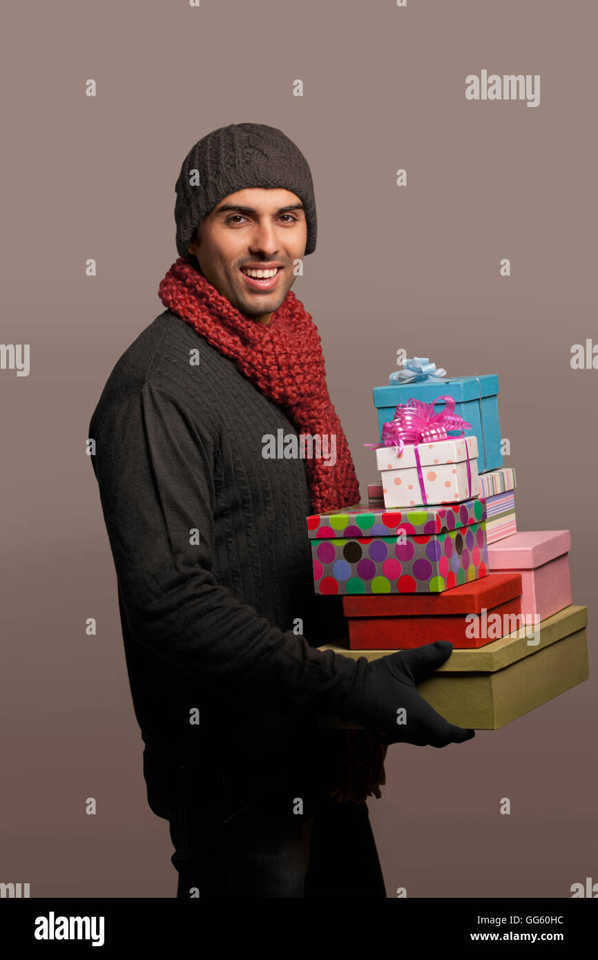 Man holding gift boxes Stock Photo - Alamy