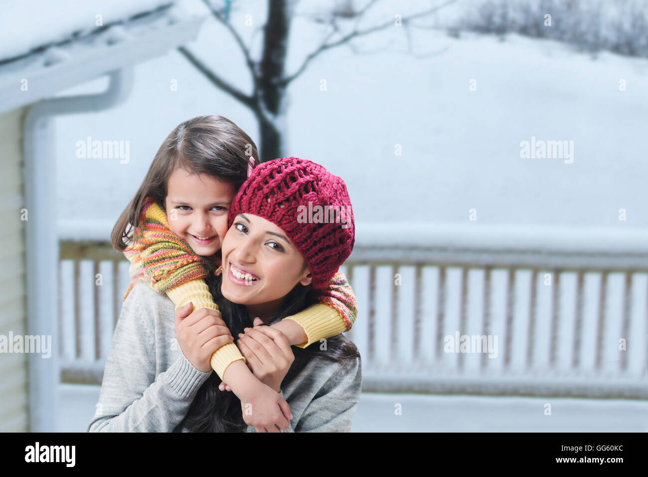 Woman giving girl piggy back ride Stock Photo - Alamy