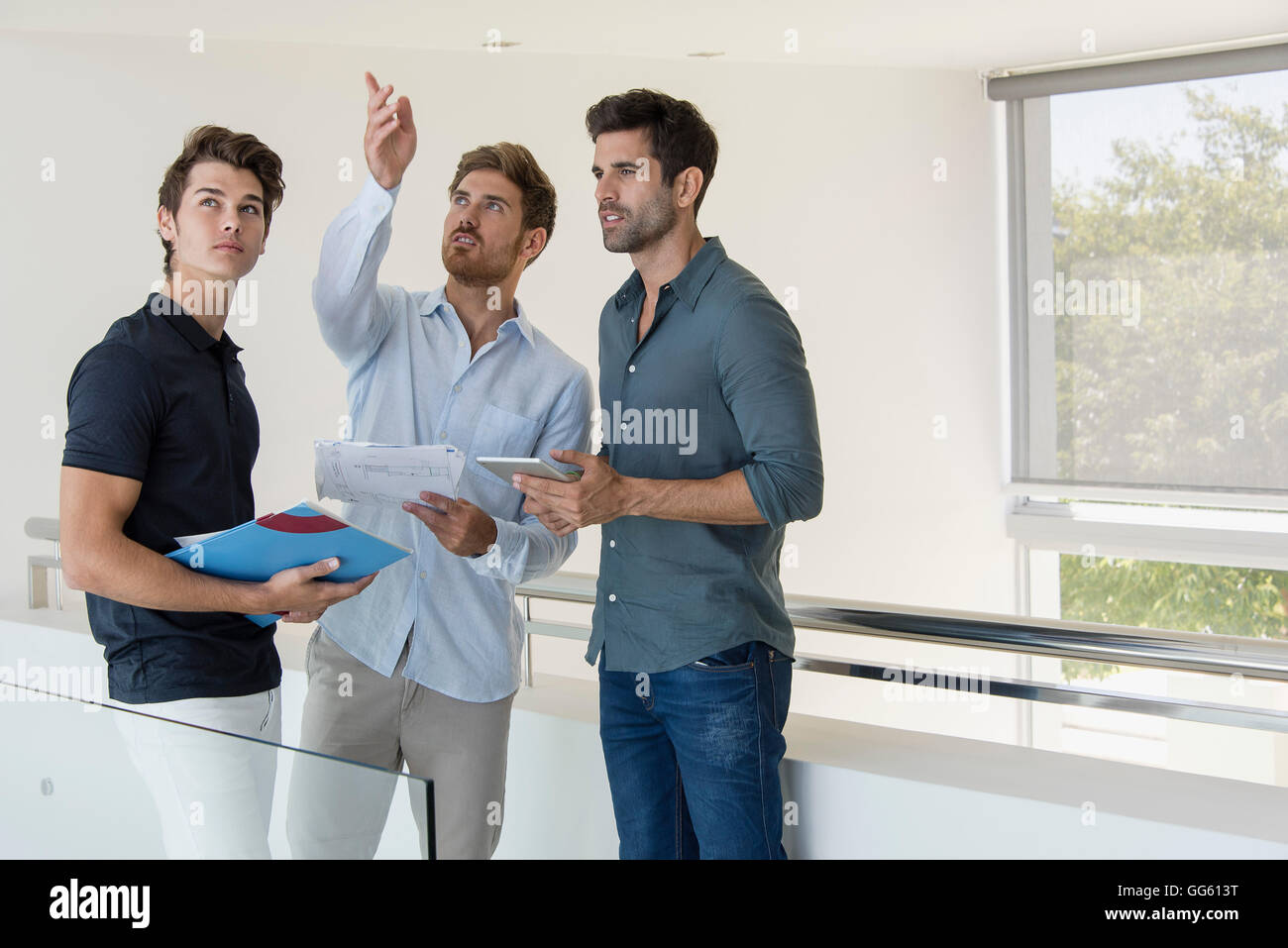Three male friends discussing Stock Photo - Alamy