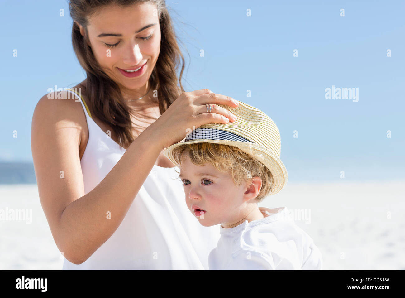 Child putting on sun hat hi-res stock photography and images - Alamy