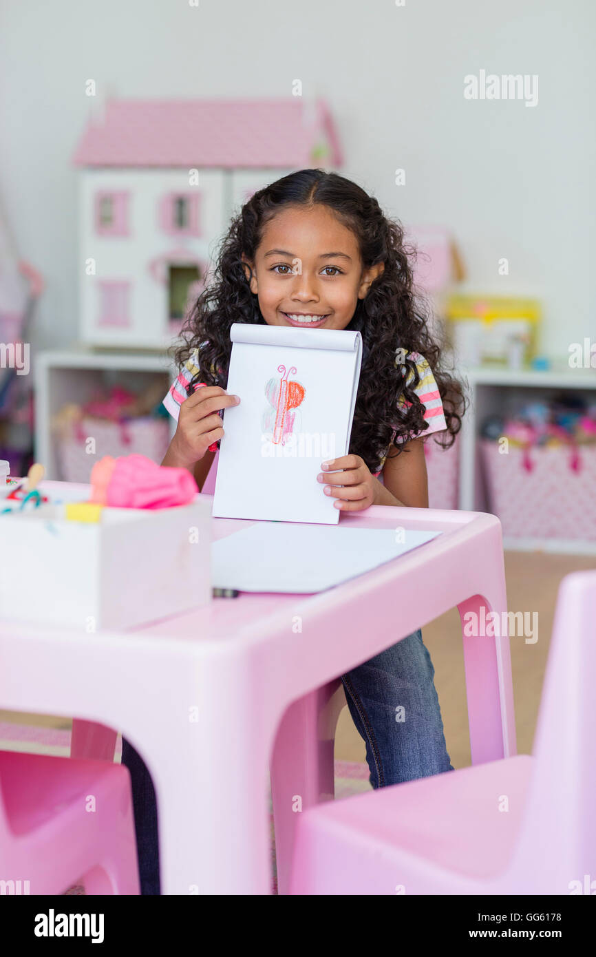 Portrait of happy little girl showing her drawing Stock Photo - Alamy
