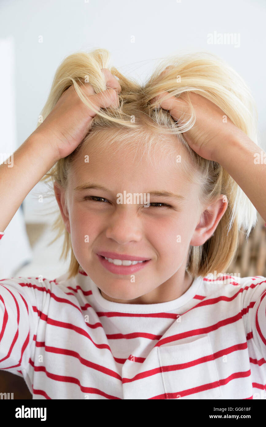 Close-up of a little girl scratching hair Stock Photo - Alamy