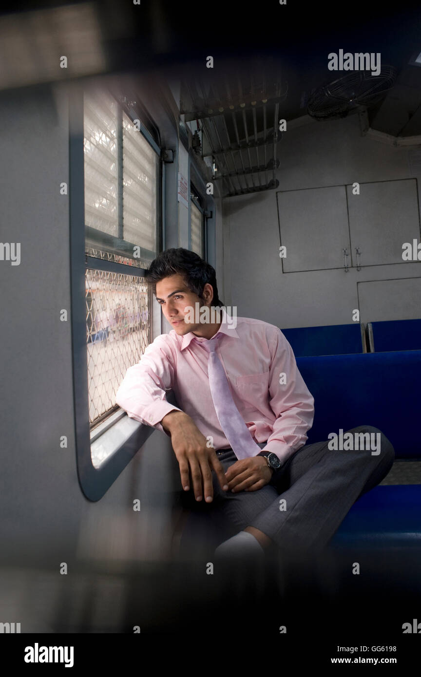 Businessman sitting inside a train Stock Photo - Alamy