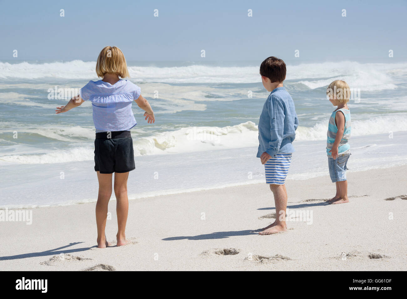 Three children standing hi-res stock photography and images - Alamy