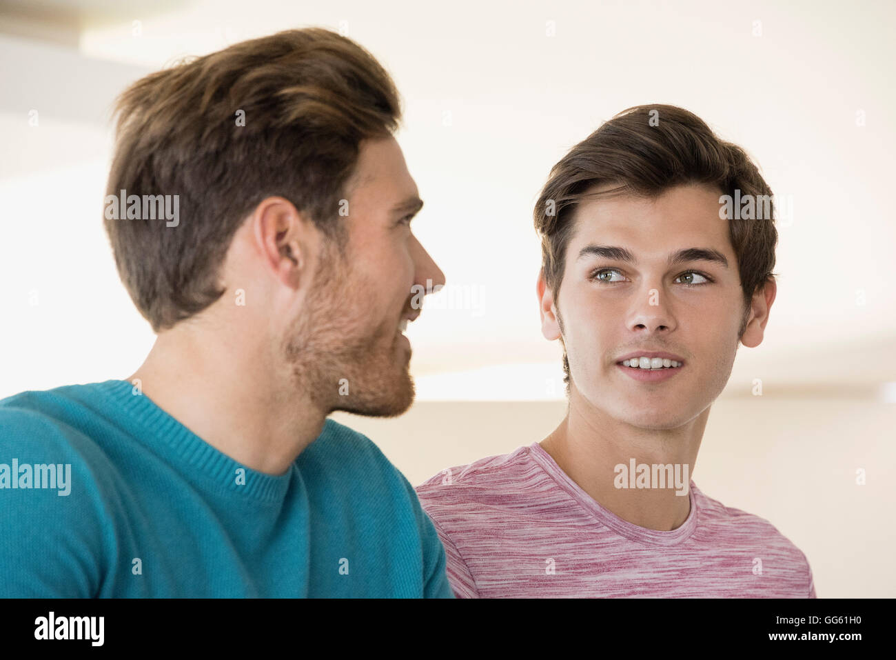 Close-up of two happy male friends talking Stock Photo - Alamy