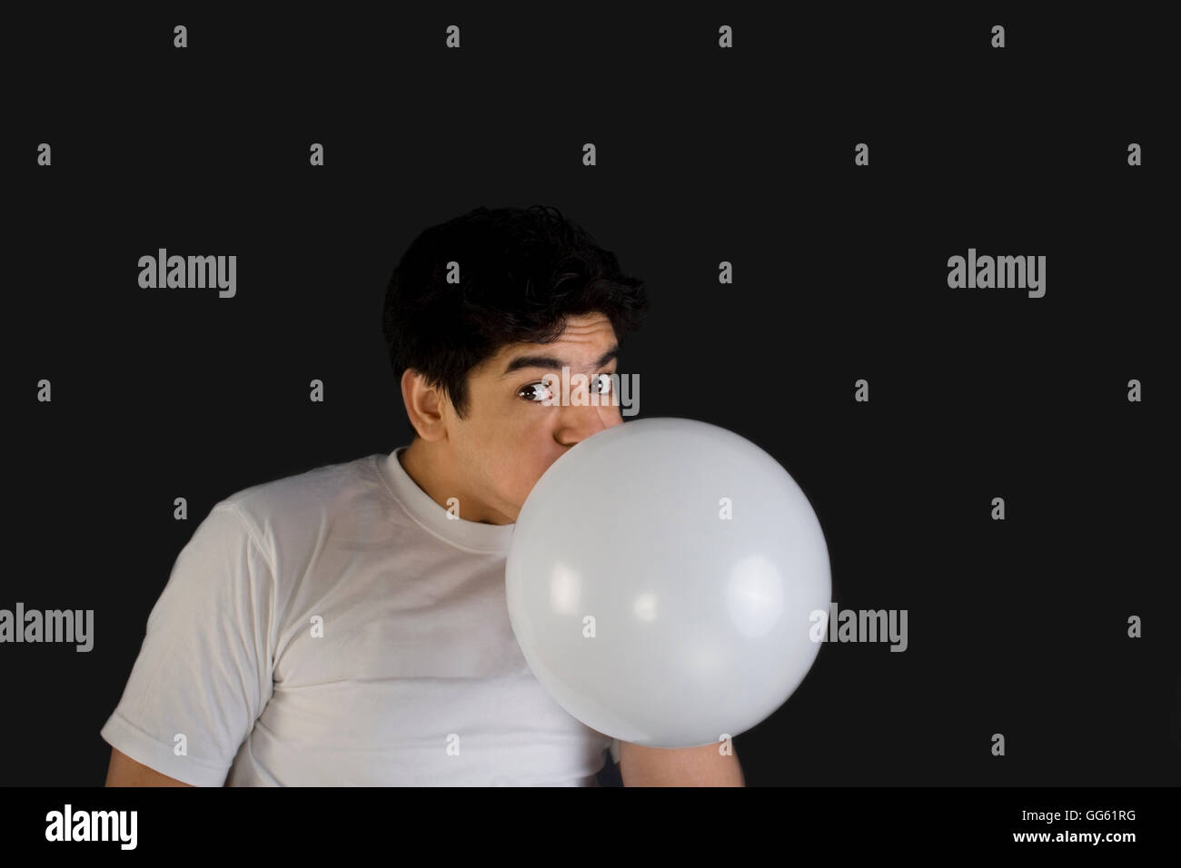 Man blowing air into a balloon Stock Photo - Alamy