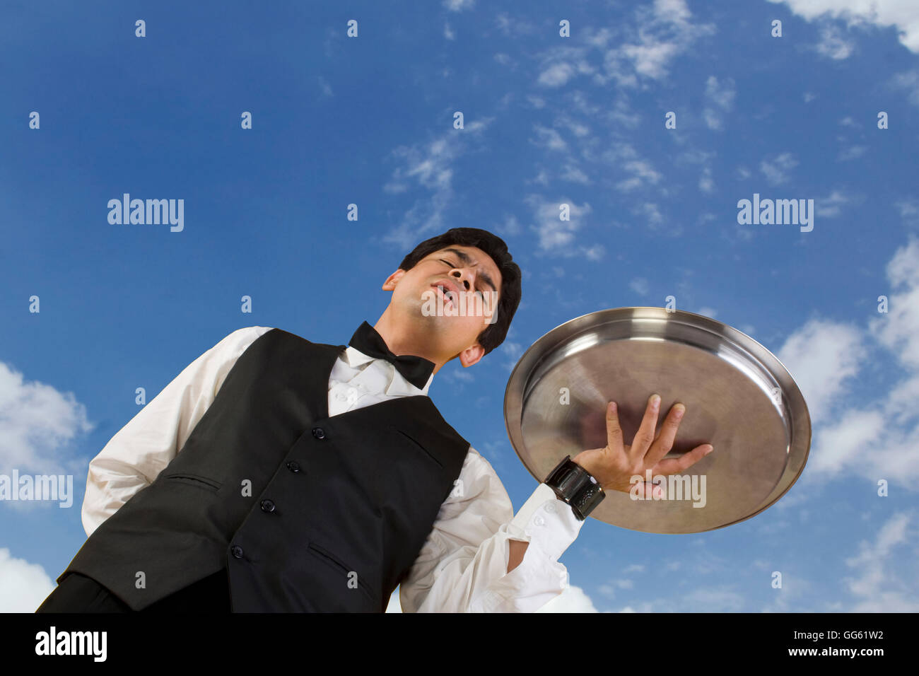 Butler holding a tray Stock Photo - Alamy