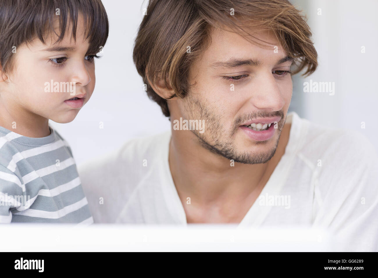 Close-up of father and son looking down Stock Photo - Alamy