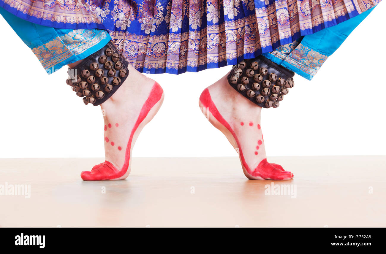 Traditional dancer's feet performing Bharatanatyam over white ...