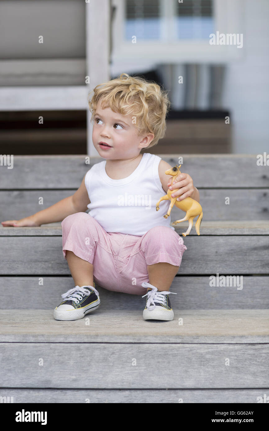 Boy sitting on steps hi-res stock photography and images - Alamy