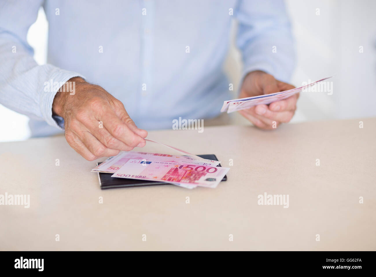 Mid section view of a senior man counting currency notes Stock Photo ...