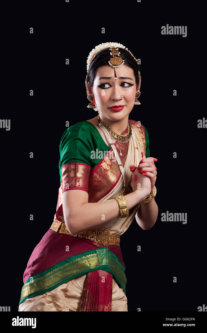 Scared Bharatanatyam dancer performing over black background Stock ...