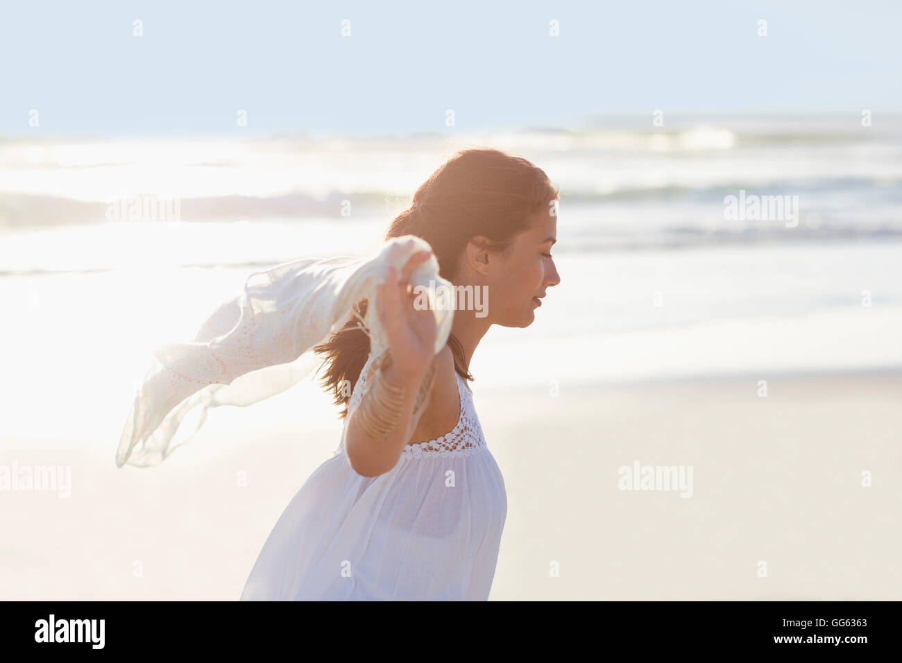 Young woman walking down beach hi-res stock photography and images - Alamy