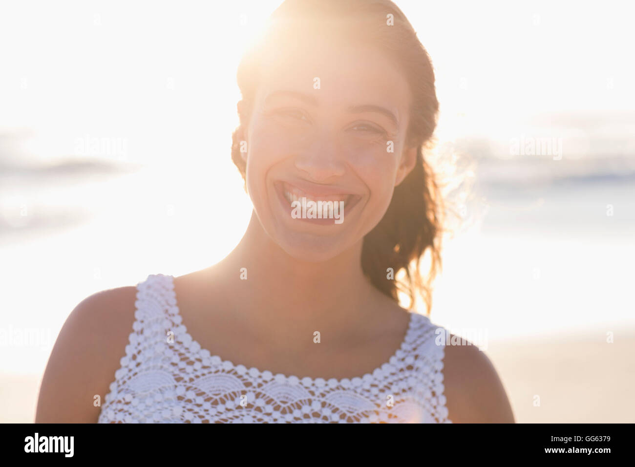 Portrait of a happy young woman smiling on beach Stock Photo - Alamy