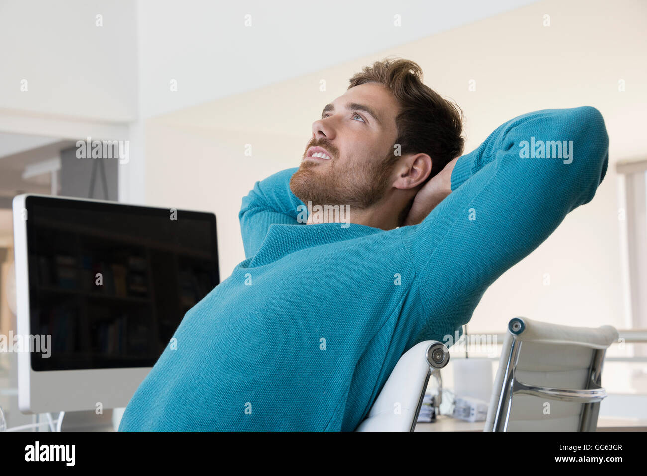 Young designer relaxing in an office Stock Photo - Alamy