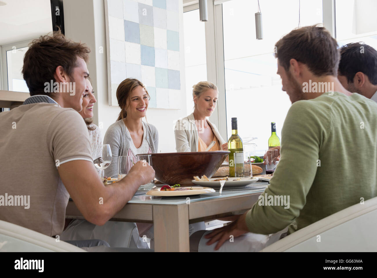 Group of happy friends having lunch at dining table Stock Photo - Alamy