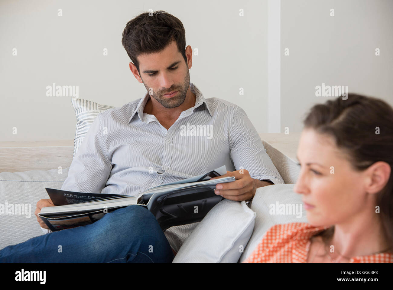 Man reading a magazine Stock Photo - Alamy