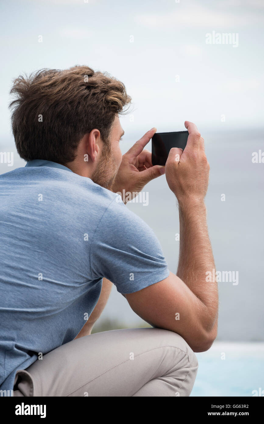 Young man using a smart phone Stock Photo - Alamy