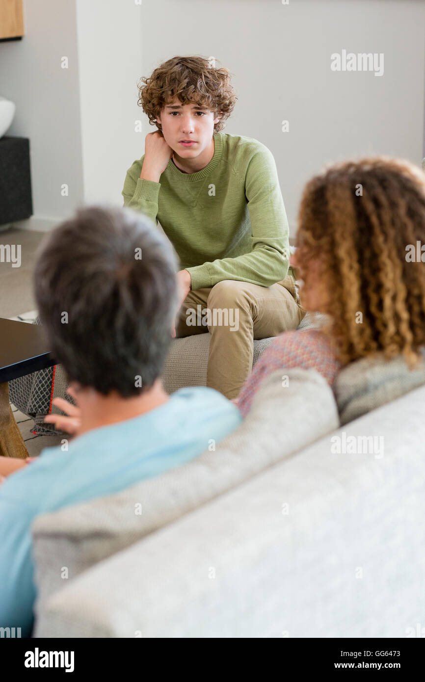 Family talking in a living room at home Stock Photo - Alamy