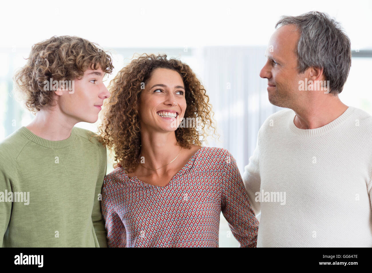 Portrait of happy family smiling at home Stock Photo - Alamy
