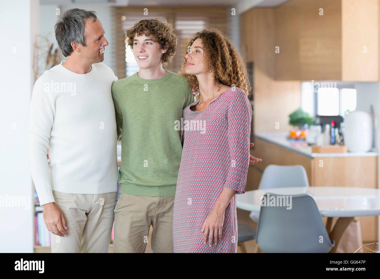 Portrait of happy family smiling at home Stock Photo - Alamy