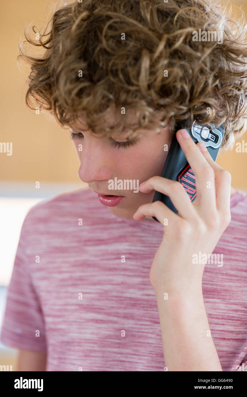 Teenage boy talking on a mobile phone at home Stock Photo - Alamy