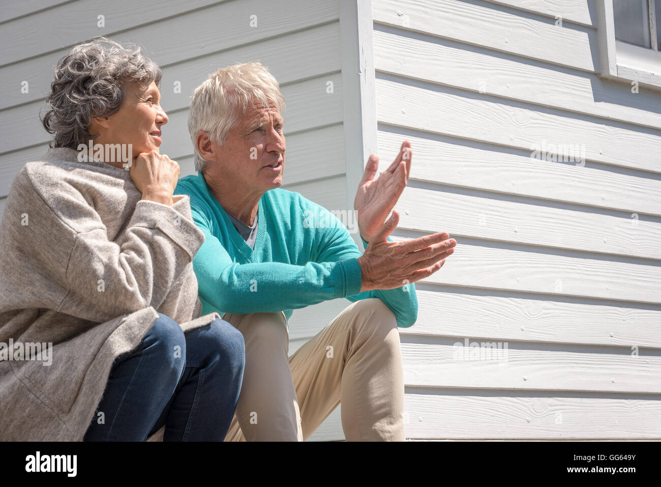 Senior couple talking outside of house Stock Photo - Alamy