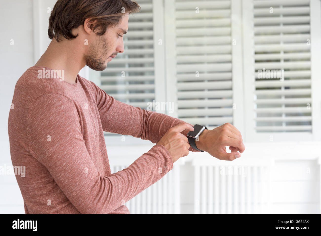 Young man using his smart watch Stock Photo - Alamy