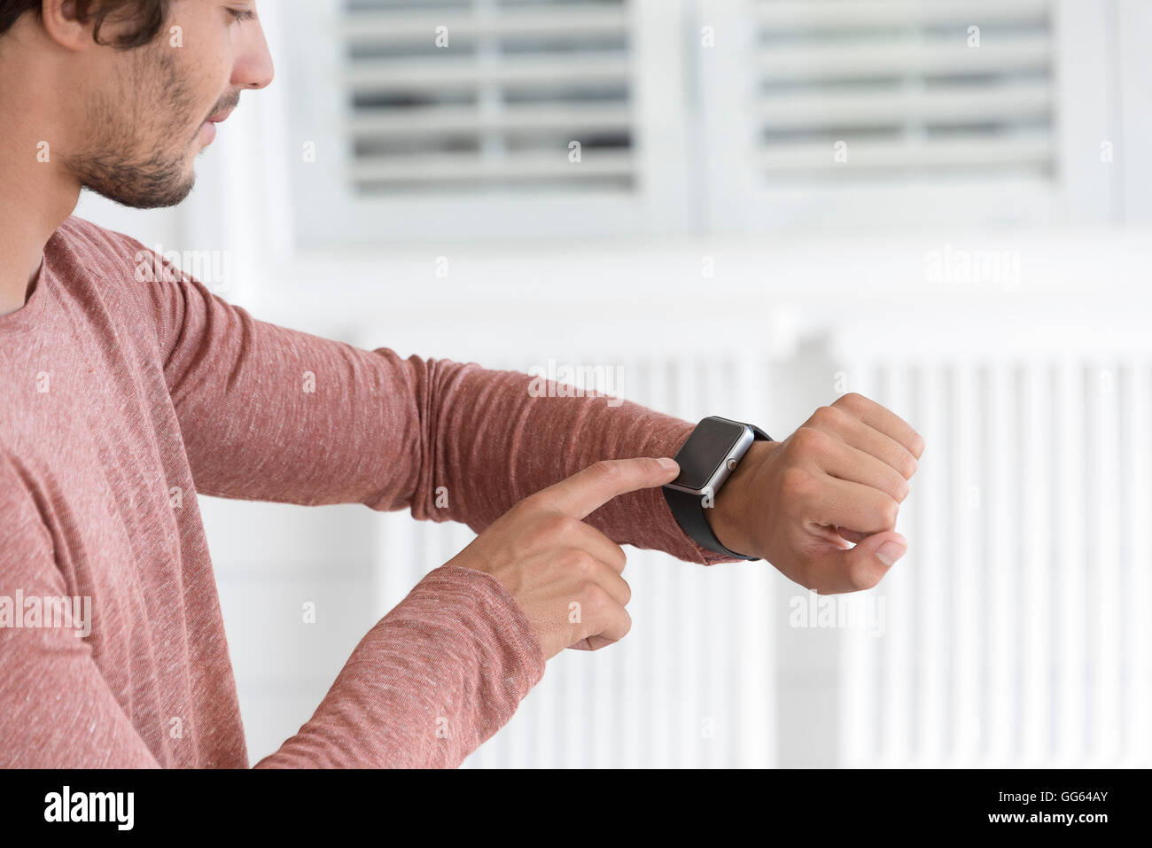 Young man using his smart watch Stock Photo - Alamy