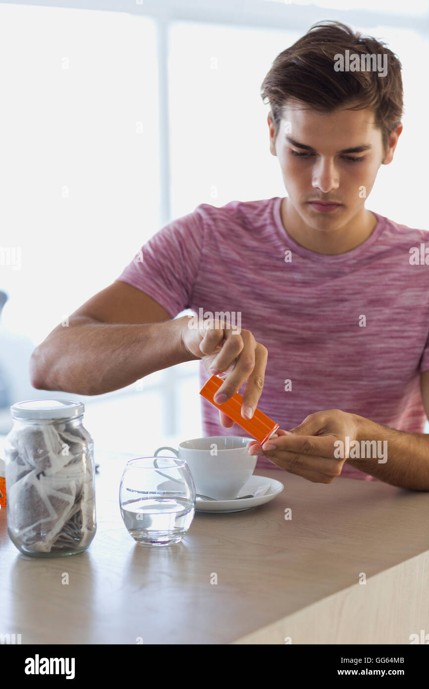 Close-up of a young man taking vitamin tablet Stock Photo - Alamy