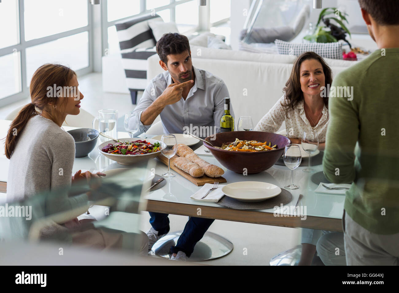 Friends around a dining table at home Stock Photo - Alamy