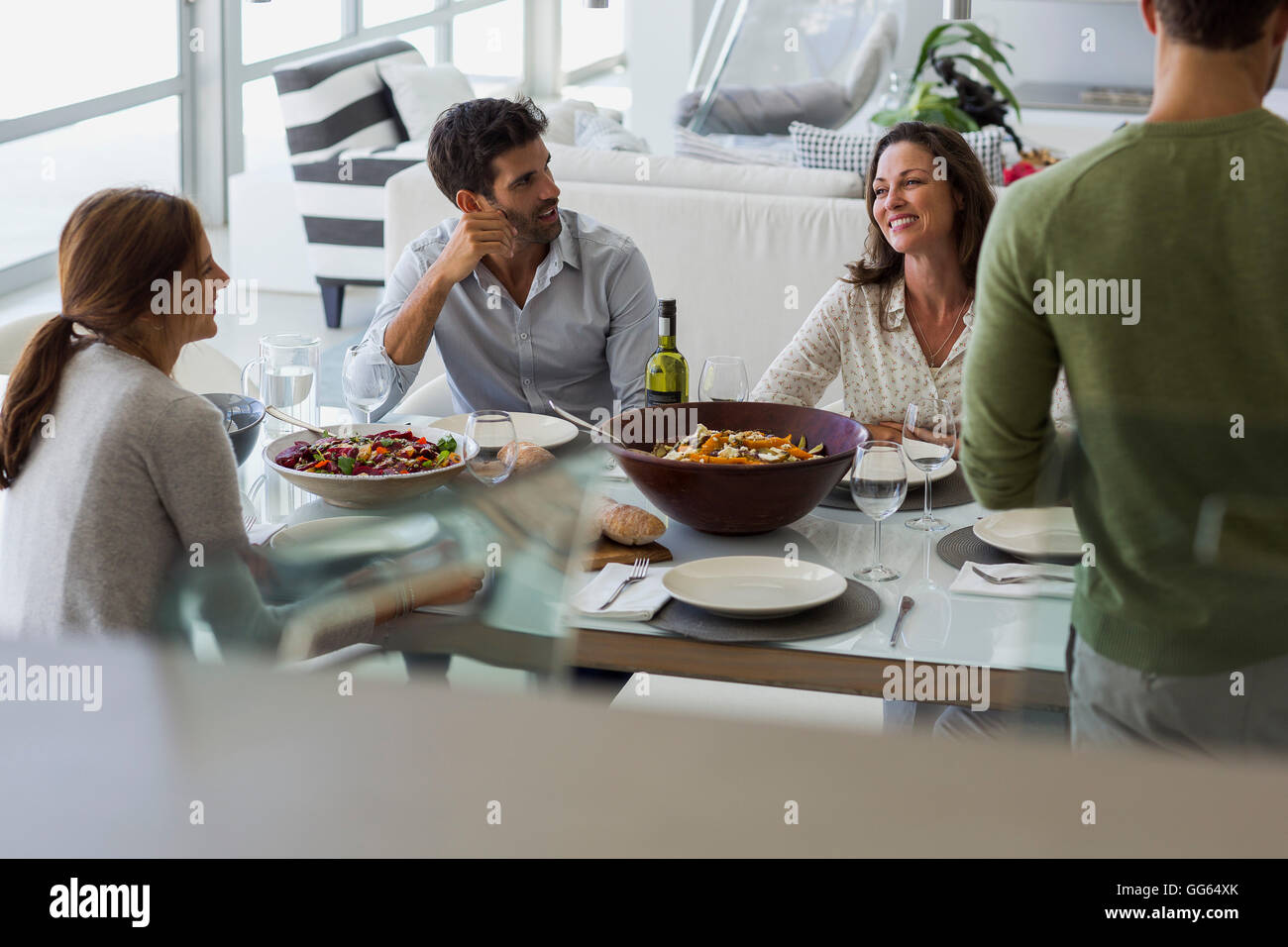 Four men sitting around table hi-res stock photography and images - Alamy