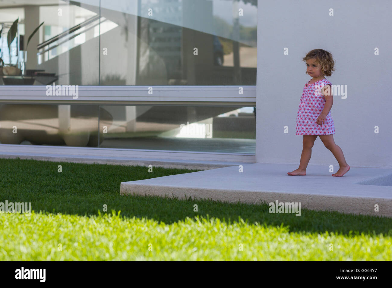 Baby girl playing in backyard of the house Stock Photo - Alamy