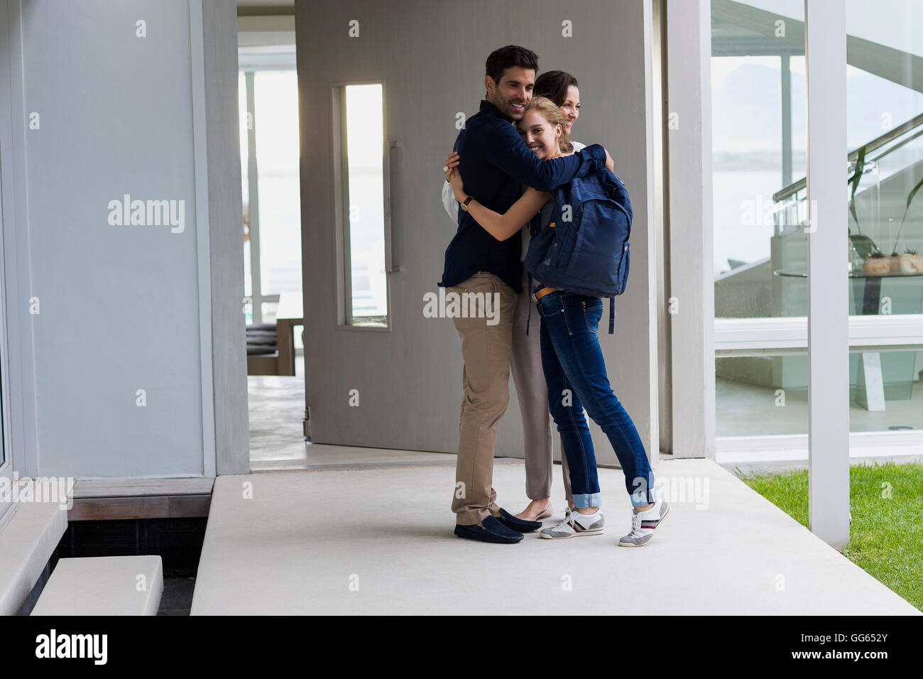 Man hugging his daughter with his wife standing beside him Stock Photo ...