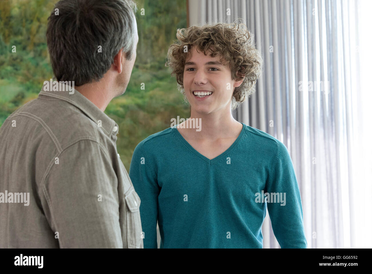 Happy father and son talking at home Stock Photo - Alamy
