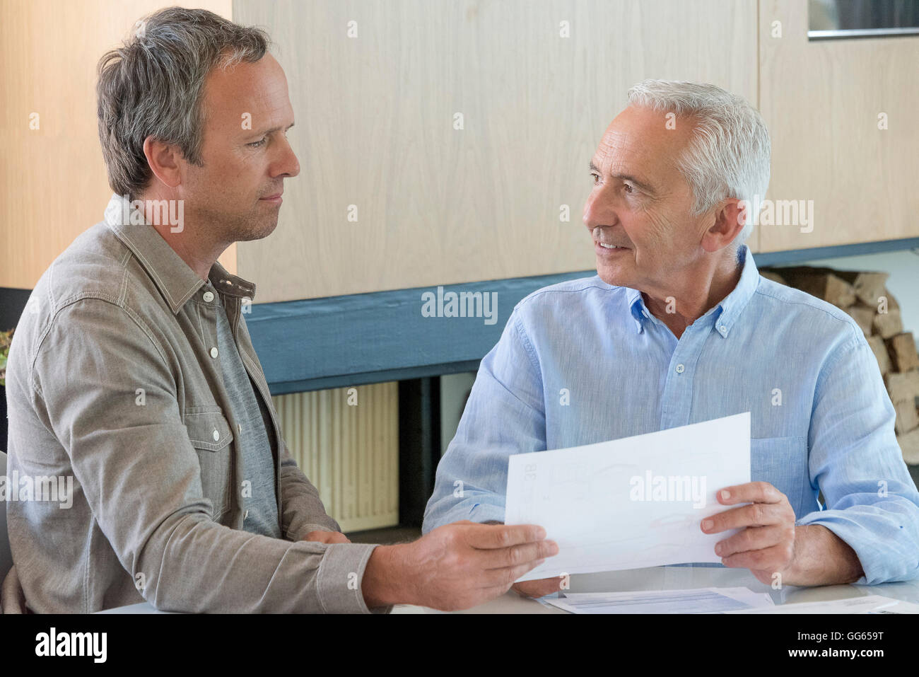 Senior man meeting with financial advisor at home Stock Photo - Alamy