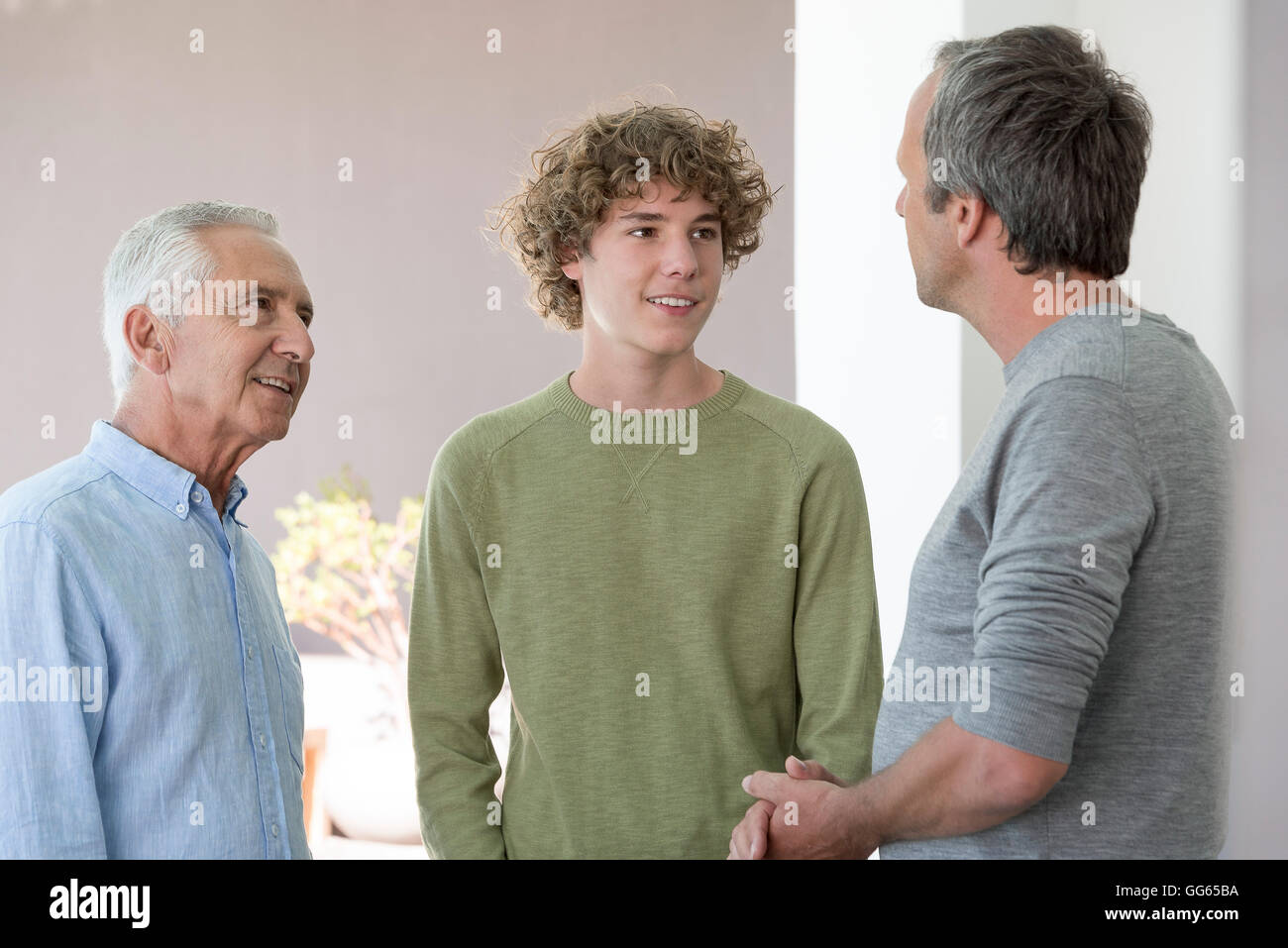 Happy multi-generation males talking Stock Photo - Alamy