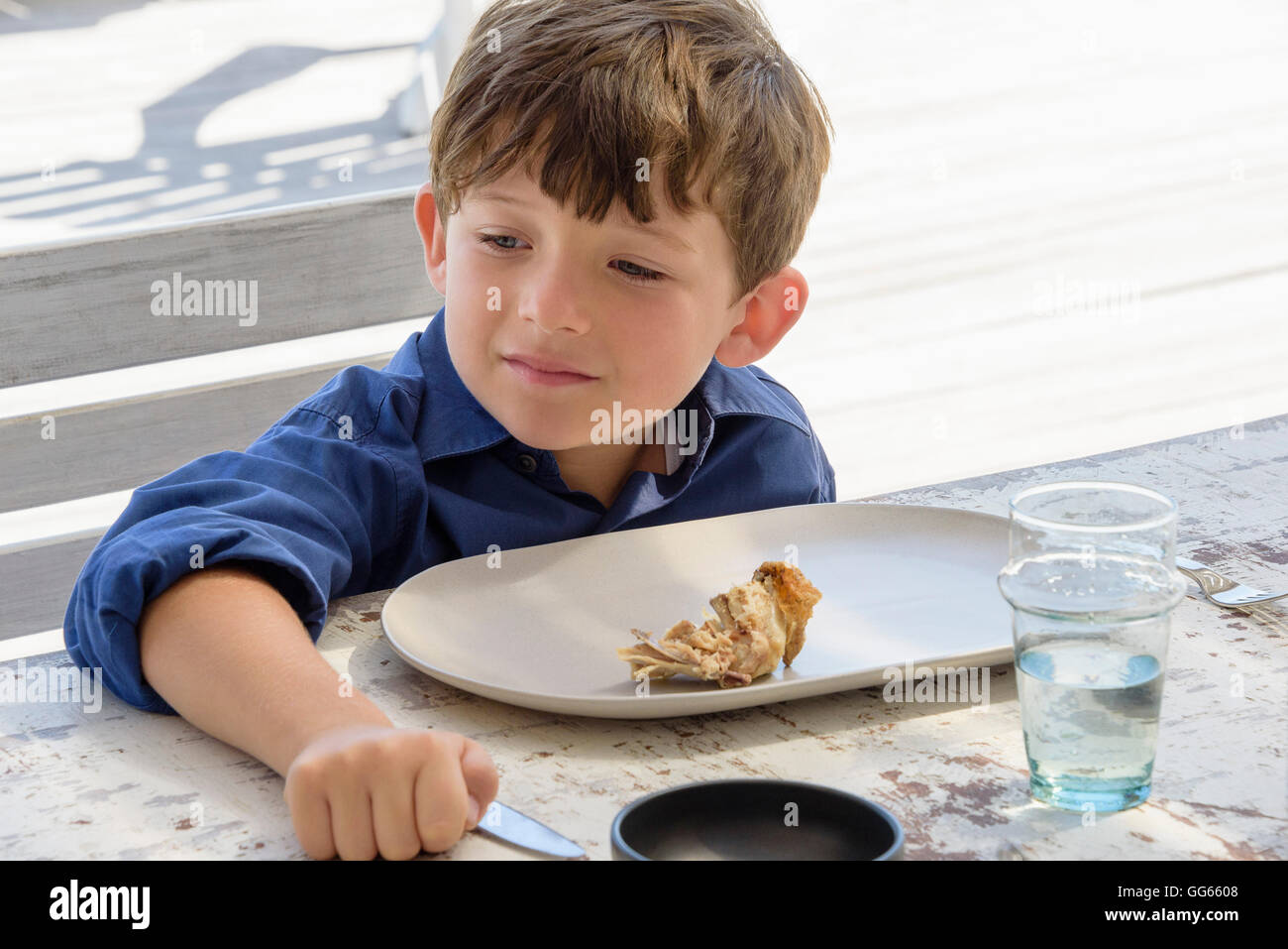 Happy little boy enjoying meal Stock Photo - Alamy