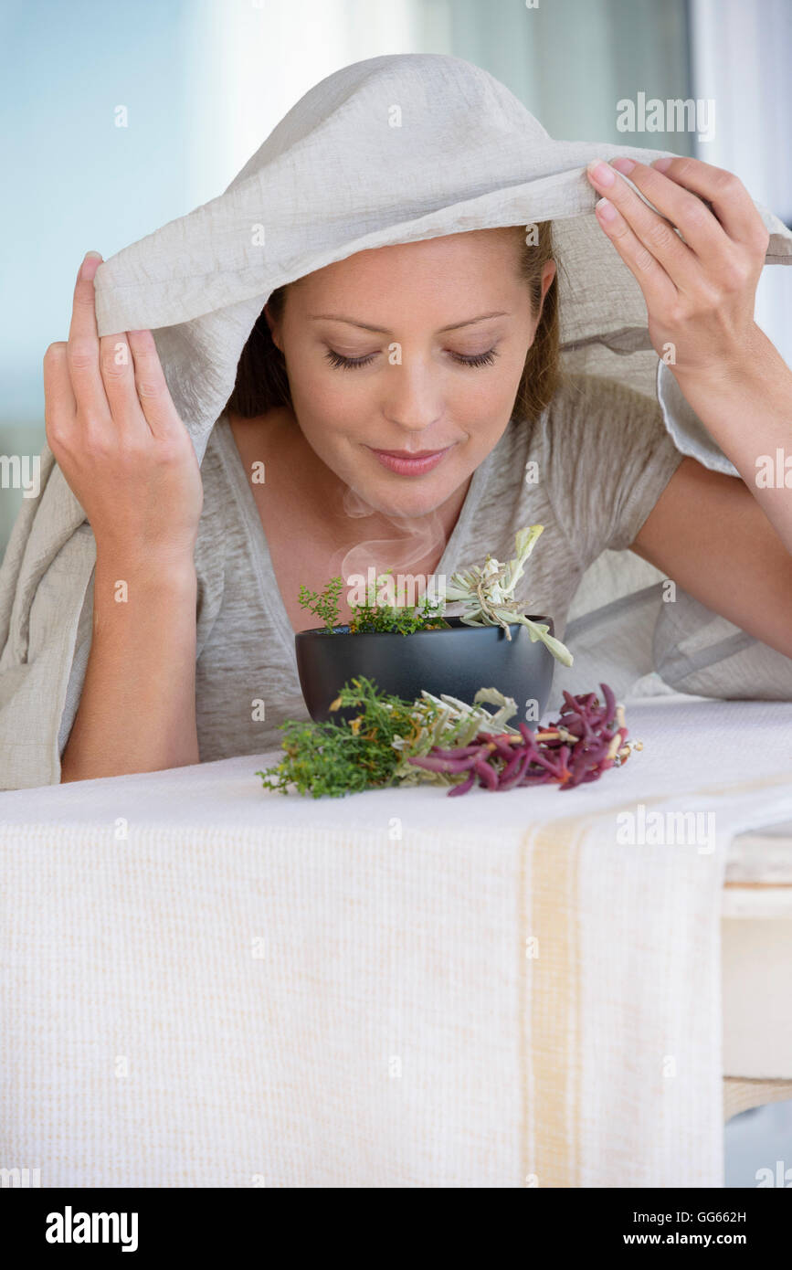 Beautiful woman smelling fresh aroma herbs Stock Photo - Alamy
