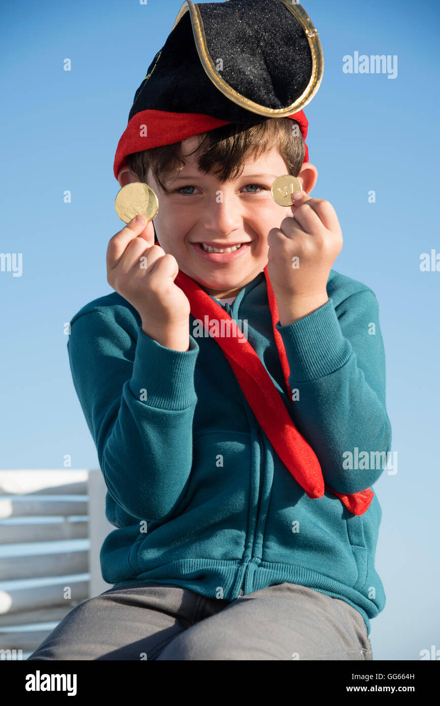 Pirate little boy showing coins Stock Photo - Alamy