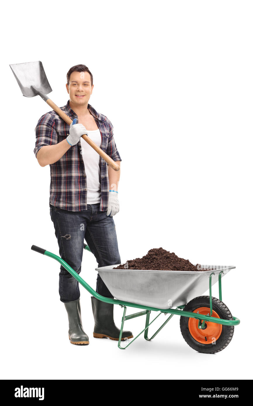 Full length portrait of a male gardener holding a shovel and posing by ...