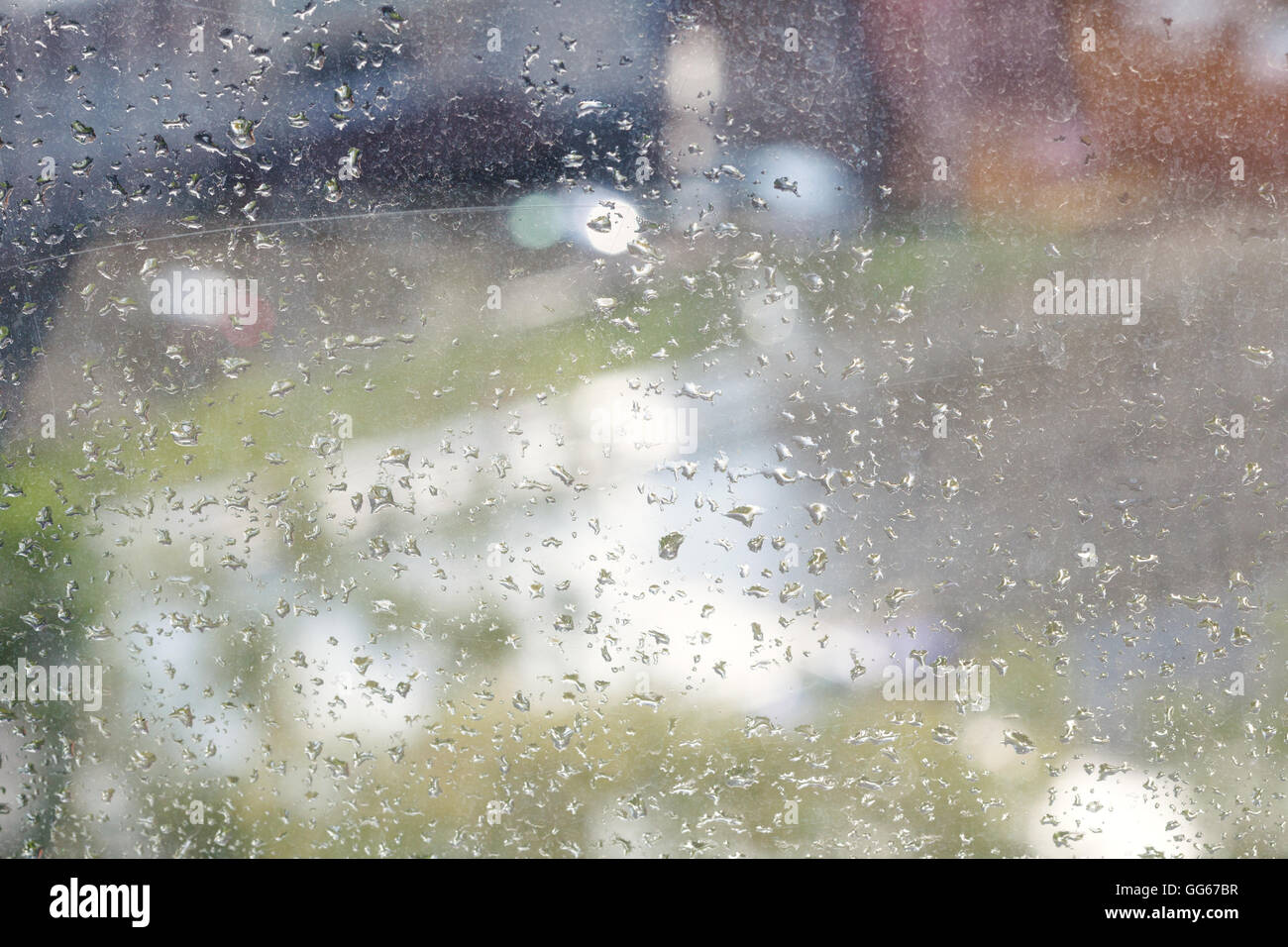 raindrops on windowpane and blurred urban street on background Stock Photo - Alamy