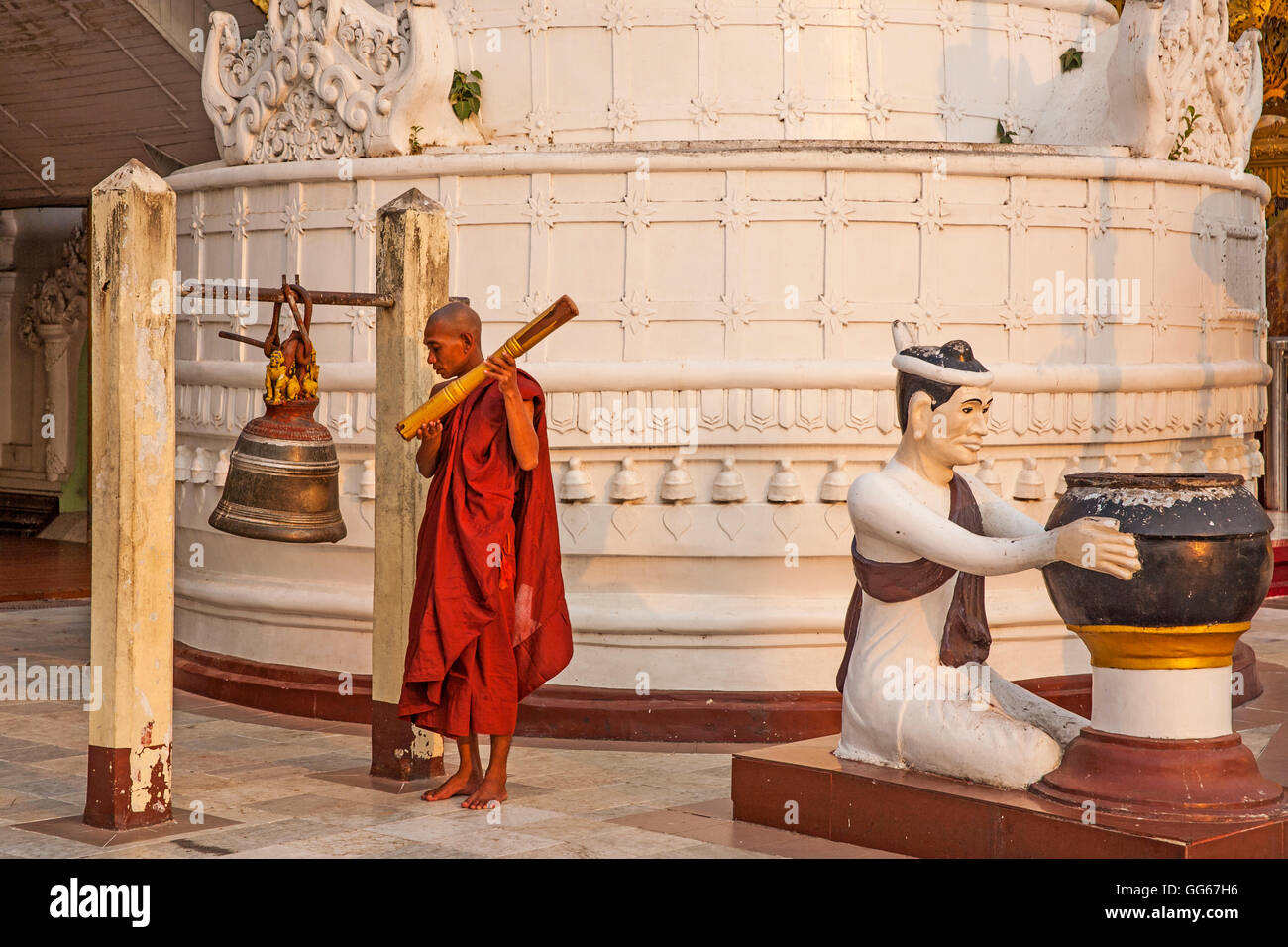 Monk ringing bell, Yangon Stock Photo - Alamy