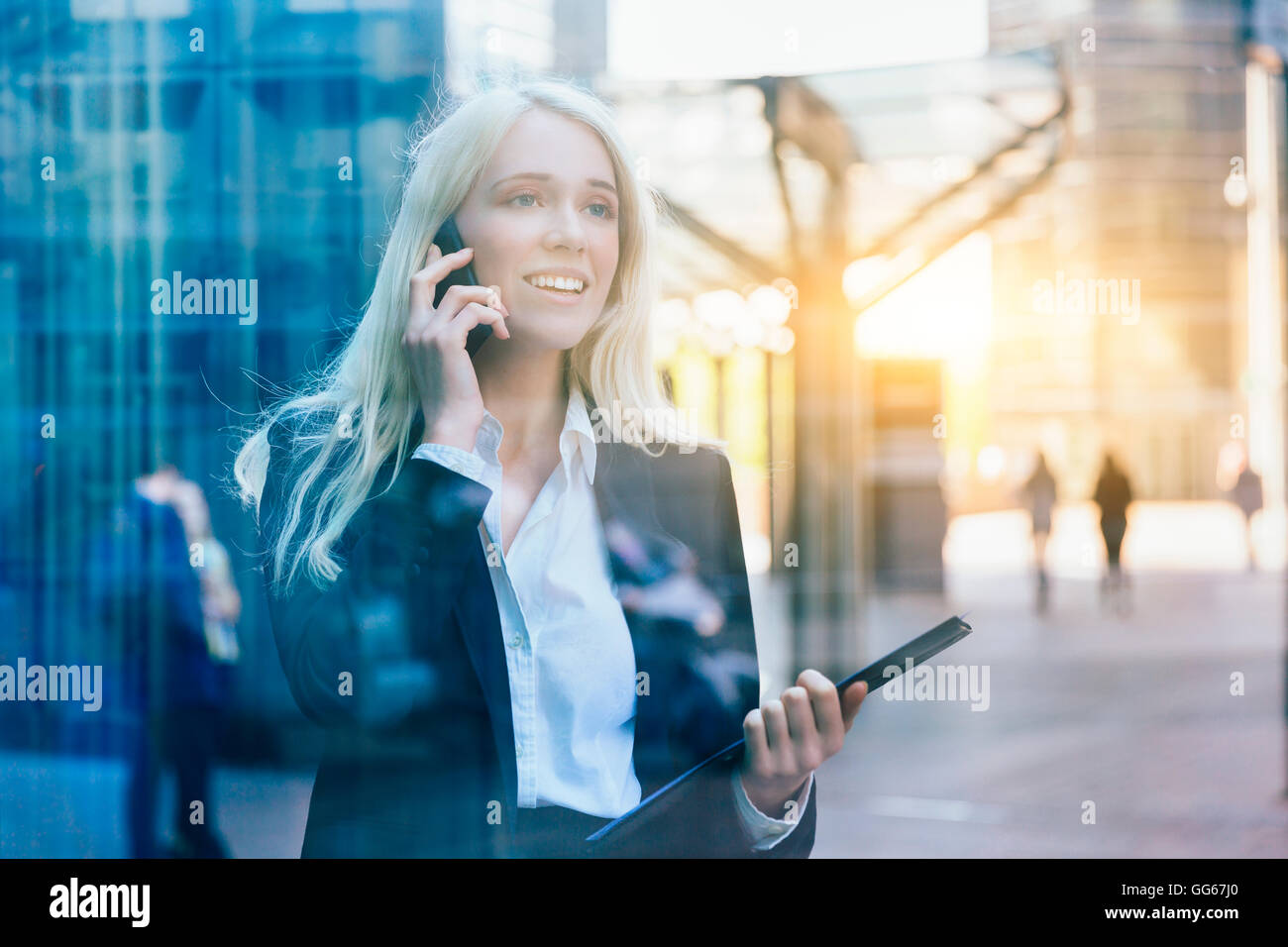 Businesswoman using a mobile phone Stock Photo - Alamy
