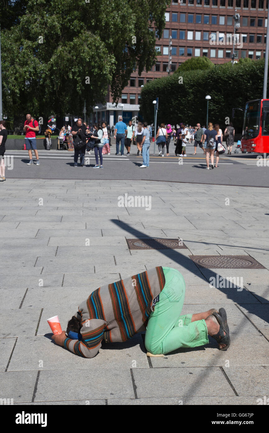Immigrant begging on Rådhusplassen square located between Oslo City ...