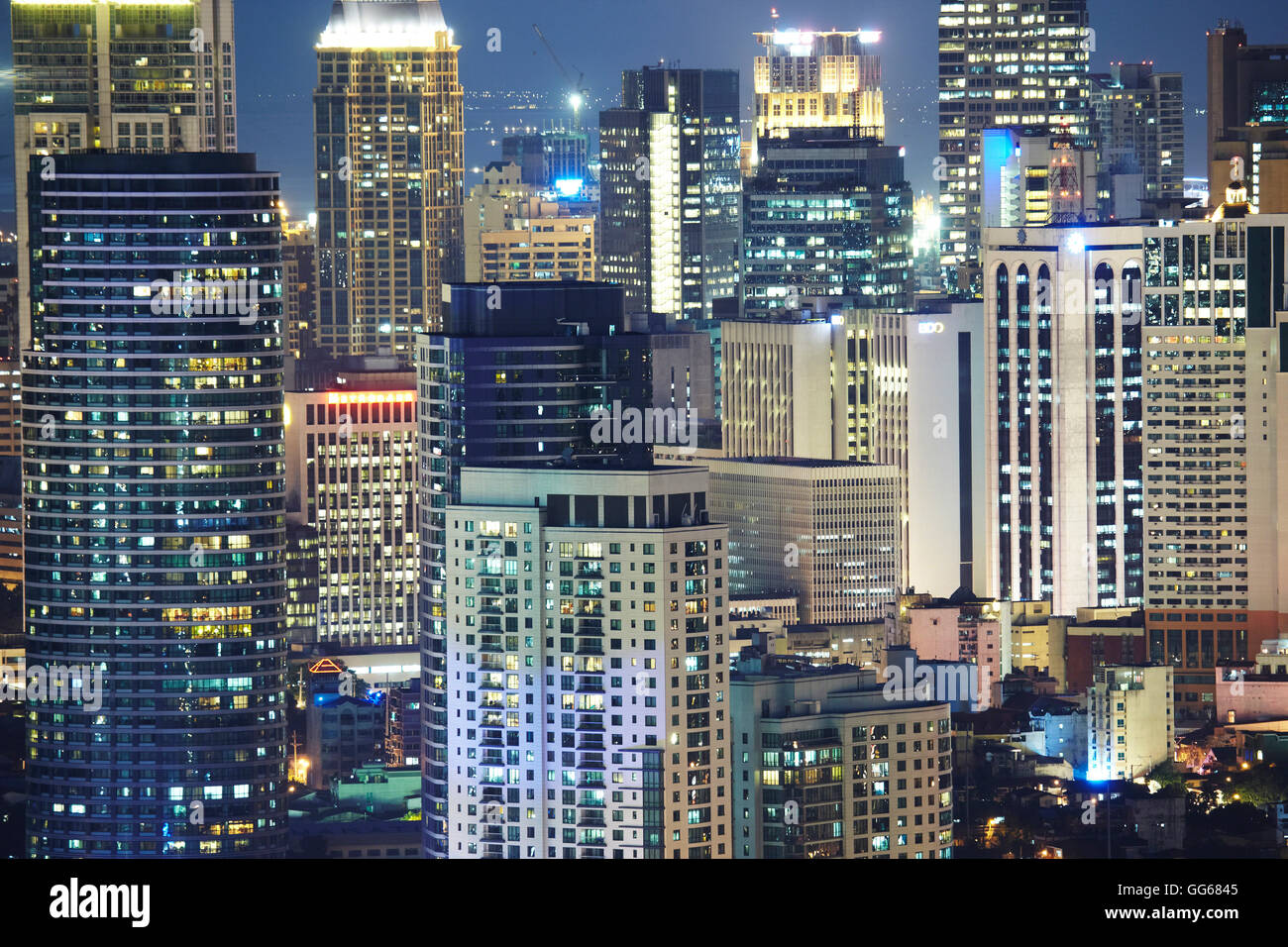 Manila skyline at night time with illuminated buildings Stock Photo - Alamy