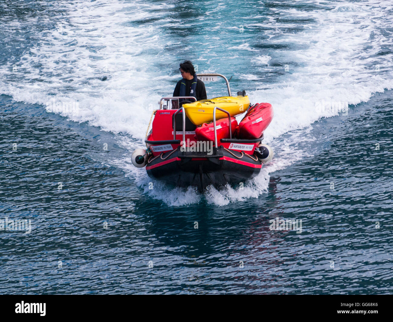 Male cruise ship staff member returning kayaks to cruise ship on Polar ...