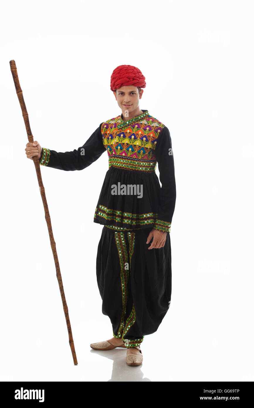Portrait of a male dandiya dancer with a stick Stock Photo - Alamy