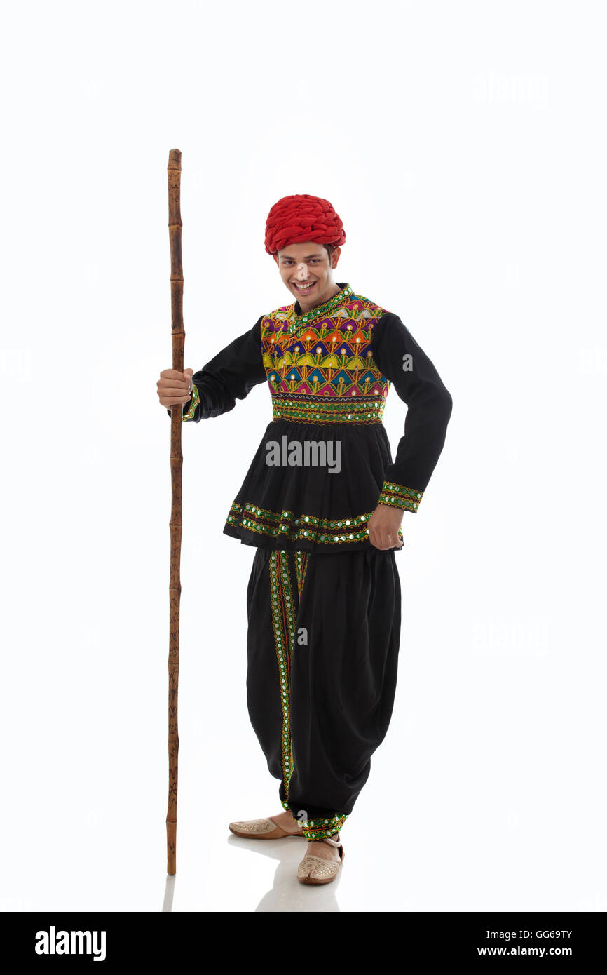 Portrait of a male dandiya dancer with a stick Stock Photo - Alamy